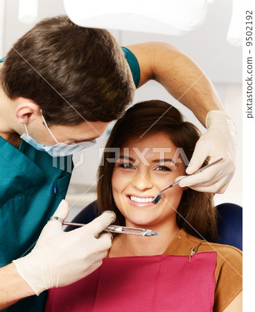 Dentist making anaesthetic injection to woman... - Stock Photo [9502192 ...