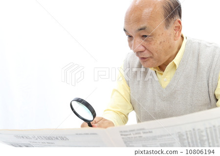 Senior viewing newspaper with magnifying glass - Stock Photo [10806194 ...