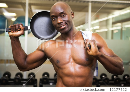 Stock Photo: Shirtless muscular man holding frying pan in gym - Stock ...