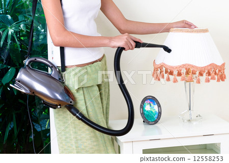 Housewife cleaning the lamp by vacuum cleaner - Stock Photo [12558253 ...