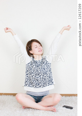 A young woman sitting while walking and... - Stock Photo [12617209] - PIXTA
