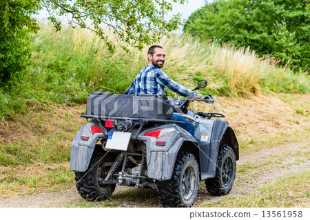 Man driving off-road with quad bike or ATV - Stock Photo [13561958] - PIXTA