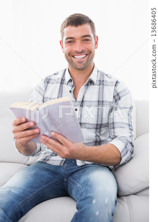 Handsome smiling man reading a book Images - Search Images on Everypixel