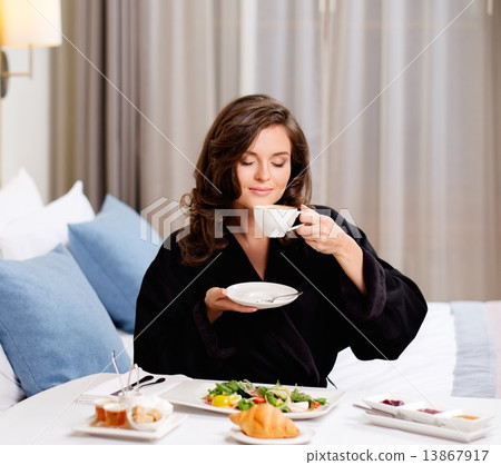 Beautiful woman having breakfast in a hotel room - Stock Photo ...