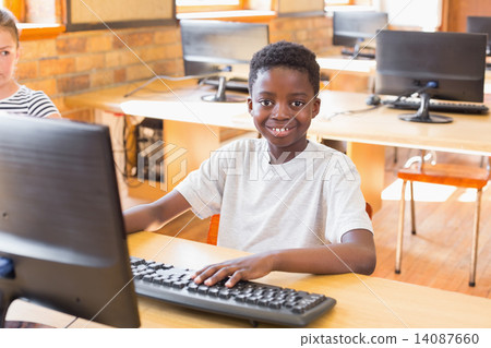 Stock Photo: Cute pupil in computer class - Stock Image - Everypixel