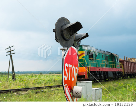 Railroad crossing signs and the approaching train - Stock Photo ...