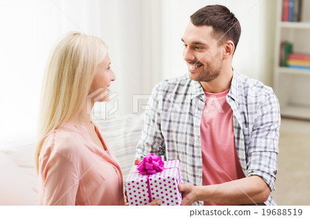 happy man giving woman gift box at home - Stock Photo [19688519] - PIXTA