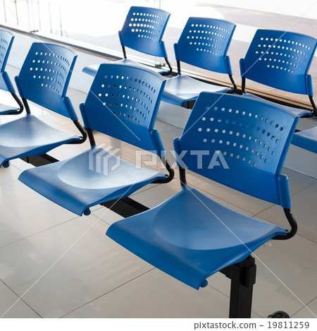 customer waiting area with rows of blue seats - Stock Photo [19811259 ...