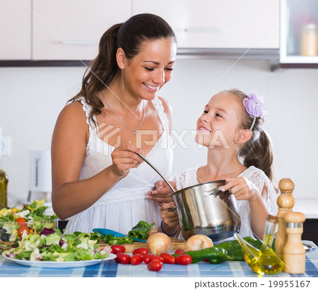 mother teaching daughter how to cook soup indoors - Stock Photo ...