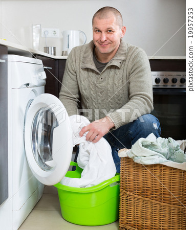 Smiling guy using washing machine - Stock Photo [19957253] - PIXTA
