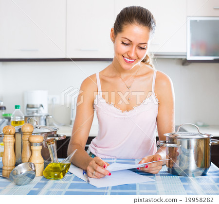 Happy young woman filling papers. - Stock Photo [19958282] - PIXTA