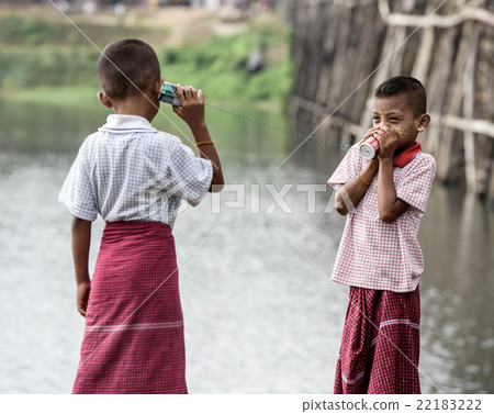 Asian boys talking on a can phone - Stock Photo [22183222] - PIXTA