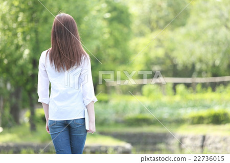 A woman walking with a tablet - Stock Photo [22736015] - PIXTA