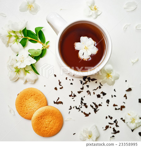 Tea cup, dried and fresh Jasmine flowers, cookies - Stock Photo ...