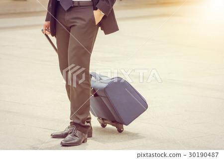 Businessman traveler with luggage at city - Stock Photo [30190487] - PIXTA
