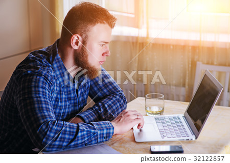 Young man working on laptop at home - Stock Photo [32122857] - PIXTA