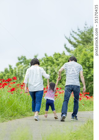 Back view of a family of three playing in a... - Stock Photo [35370435 ...