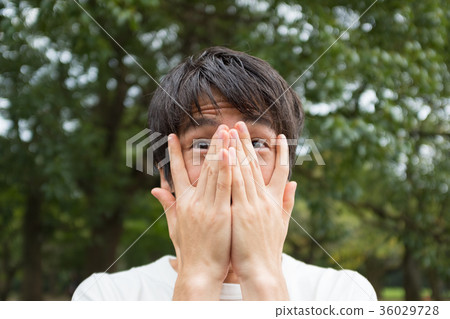 Men peeking through the finger gap - Stock Photo [36029728] - PIXTA