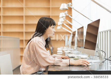 Female college student using computer in library - Stock Photo ...