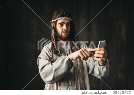 Man in the image of Jesus Christ holds phone - Stock Photo [39920797 ...