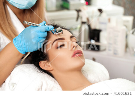 Beautician makes cleaning of face in spa salon. - Stock Photo [41601621 ...