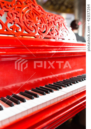 Vintage red classical grand piano. Black and white keys. Keyboard of ...