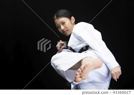 Female karateka kicks out - Stock Photo [43360027] - PIXTA
