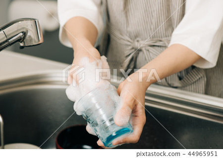 Young housewife washing a cup in the kitchen - Stock Photo [44965951 ...