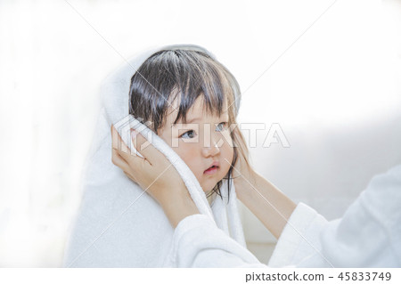 Mom wipes the little girl above the bath with a... - Stock Photo ...