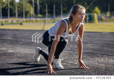 a young woman runner getting ready for a run on... - Stock Photo ...