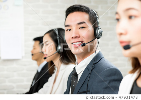 Smiling male Asian call center telemarketing agent - Stock Image ...