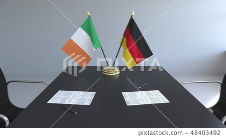 Flags of Ireland and Germany and papers on the... - Stock Illustration ...