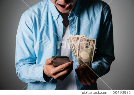 Man with cell phone and cash - Stock Photo [50493985] - PIXTA