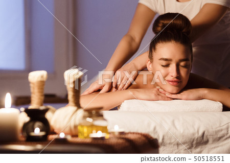 Total Relaxation. Woman In Spa Salon With Herbal Bags On Foreground ...
