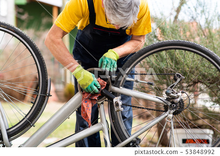 Man cleaning his bicycle for the new season - Stock Photo [53848992 ...