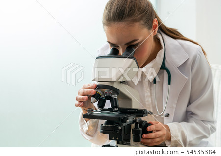 Doctor using microscope in hospital laboratory. - Stock Photo [54535384 ...
