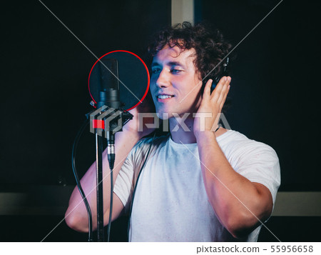 Male vocal artist with curly hair singing... - Stock Photo [55956658 ...
