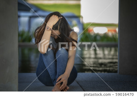 Sad young woman desperately looking at the clock - Stock Image - Everypixel