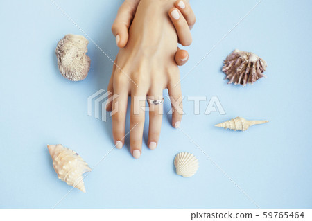 woman hand with sea shell manicured on blue... - Stock Photo [59765464 ...