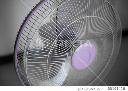 Modern violet electric fan in a living room saving peoples from hot ...