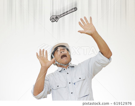 Worker surprised by falling wrench - Stock Photo [61912976] - PIXTA