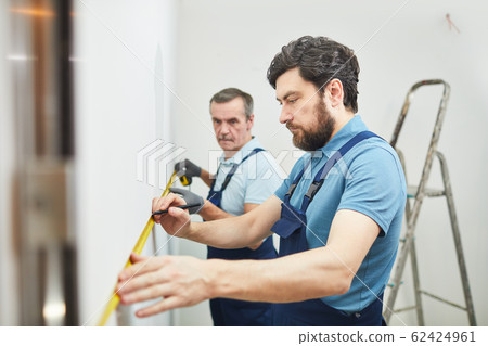 Construction Workers Measuring Wall - Stock Photo [62424961] - PIXTA