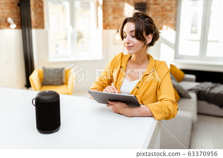 Woman controlling smart home devices with a voice commands - Stock ...