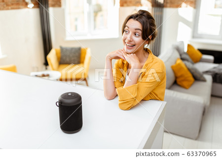 Woman controlling smart home devices with a voice commands - Stock ...