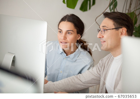 Mentor helping intern explaining trainee or new... - Stock Photo ...