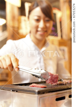 Woman grilling meat - Stock Photo [67053274] - PIXTA