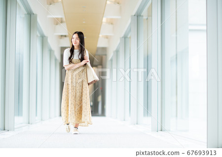 Young woman walking in the hallway of the... - Stock Photo [67693913 ...