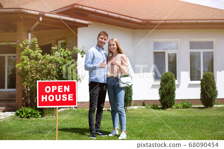 Happy home owners with house key in front of... - Stock Photo [68090454 ...