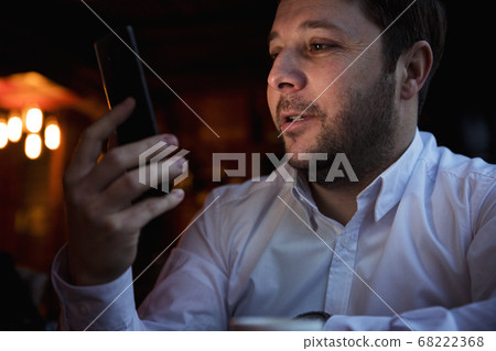 Man looking at smartphones screen in the dark... - Stock Photo ...