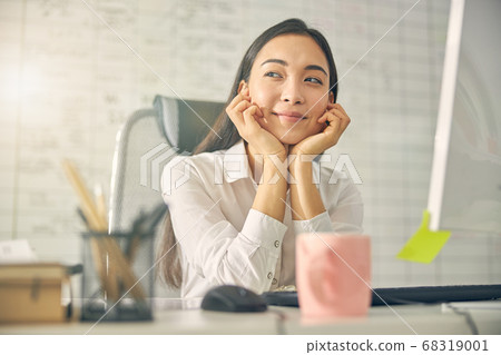 Charming young woman sitting at her workplace - Stock Photo [68319001 ...